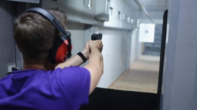 Man Shoots at Target with Pistol in Shooting Range. Stock Image - Image ...