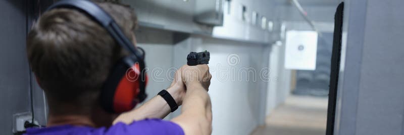 Man Shoots at Target with Pistol in Shooting Range. Stock Image - Image ...