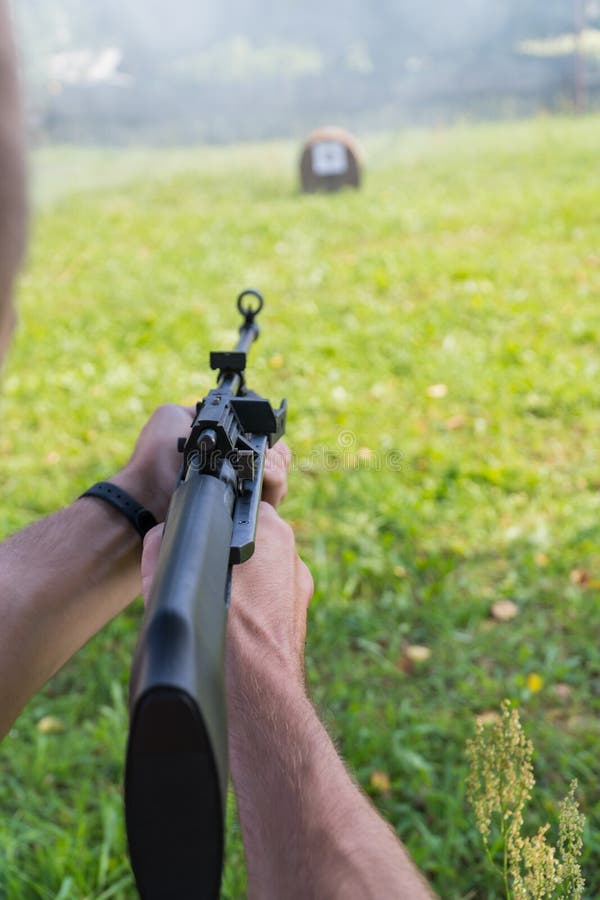 A Man Shoots a Target from a Pneumatic Gun. a View from Behind the ...