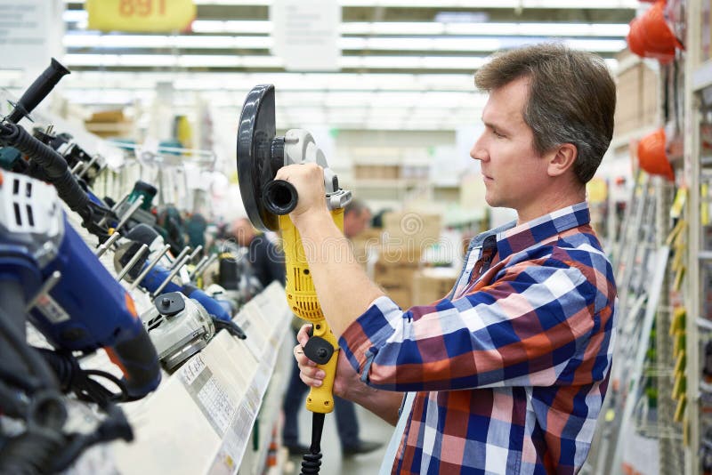 Man Shopping for Angle Grinder in Hardware Store Stock Photo - Image of ...