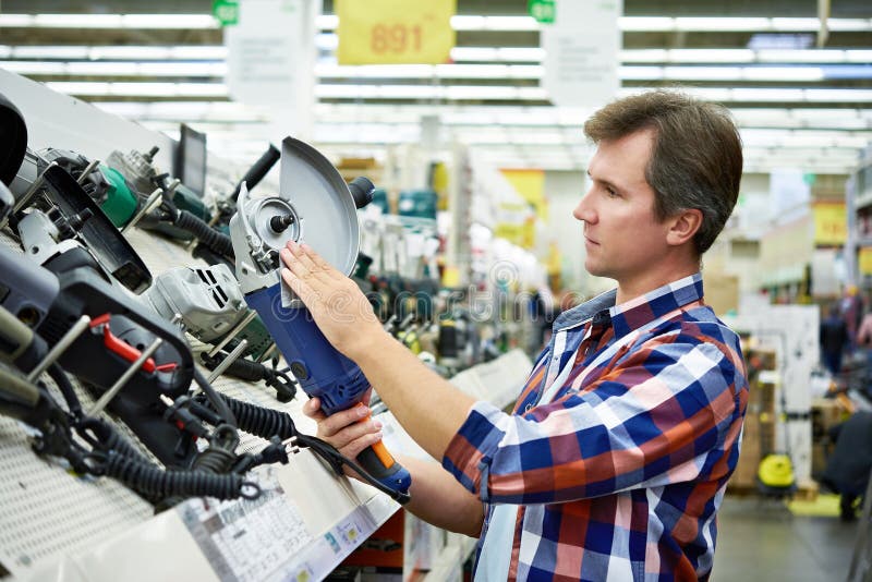 Man Shopping for Angle Grinder in Hardware Store Stock Image - Image of ...