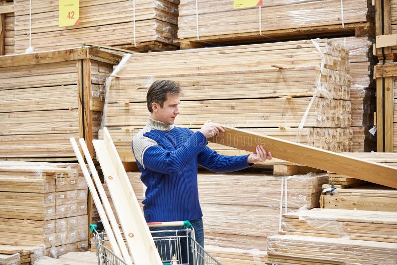 Man Shopping for Timber in Shop Stock Photo - Image of standing, color ...