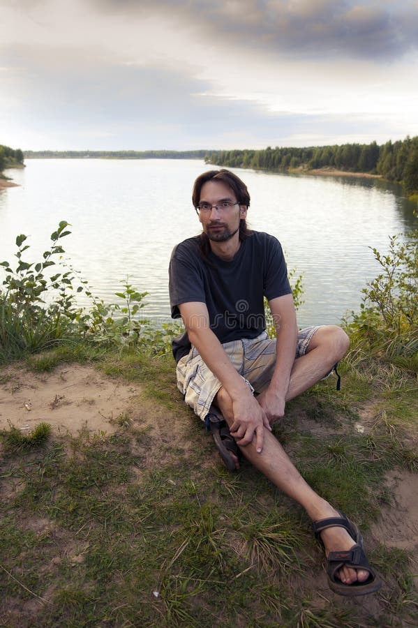 Man on the shore of lake stock image. Image of tourist - 42191263