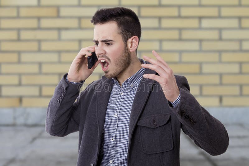 Man shouting by the phone stock photo. Image of formal - 94707980