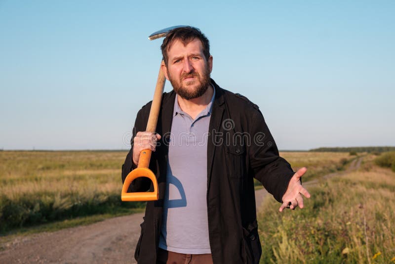 A Man with a Shovel in the Field is Provocatively Behaving Stock Image ...
