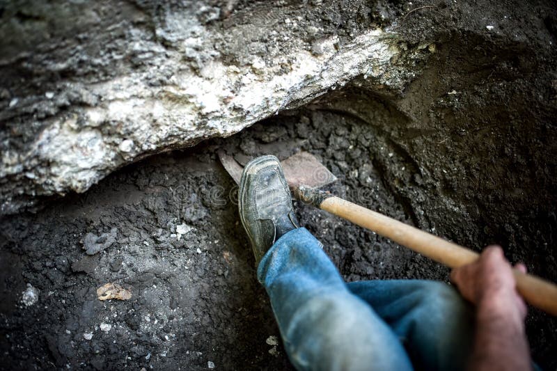 Construction Worker Digging a Deep Underground Hole with a Shove Stock ...