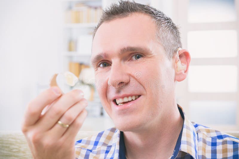 Man showing deaf aids stock image. Image of accessory - 172347337