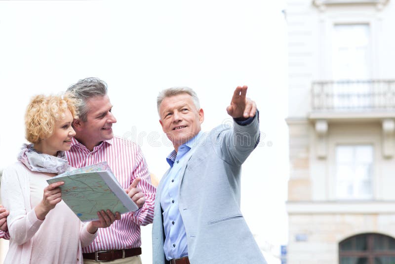 Man Showing Direction To Couple with Road Map in City Stock Image ...