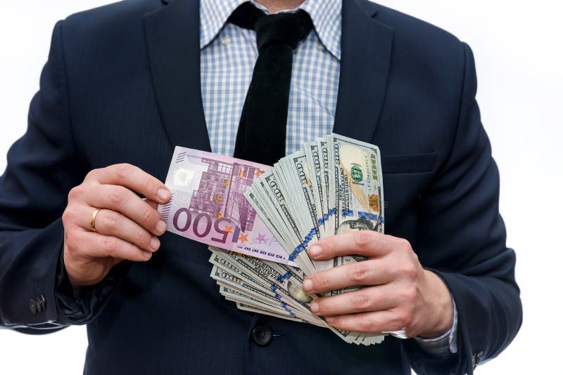 Man Showing Euro Banknote between Dollar Pile Stock Photo - Image of ...