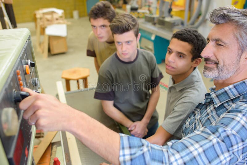 Man Showing How To Start Machine in Workshop Stock Photo - Image of ...