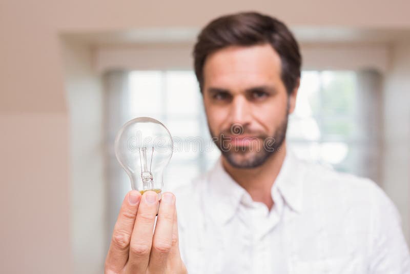 Man Showing Light Bulb To Camera Stock Image - Image of lifestyle, bulb ...