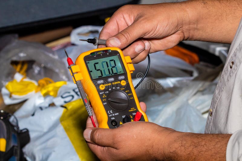 Man showing a multimeter. editorial photo. Image of electrician - 168253221