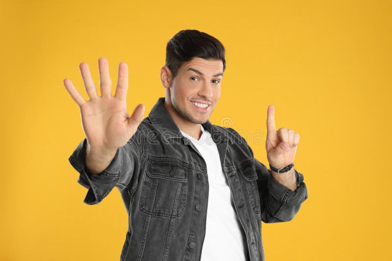 Man Showing Number Six with His Hands on Yellow Background Stock Photo ...