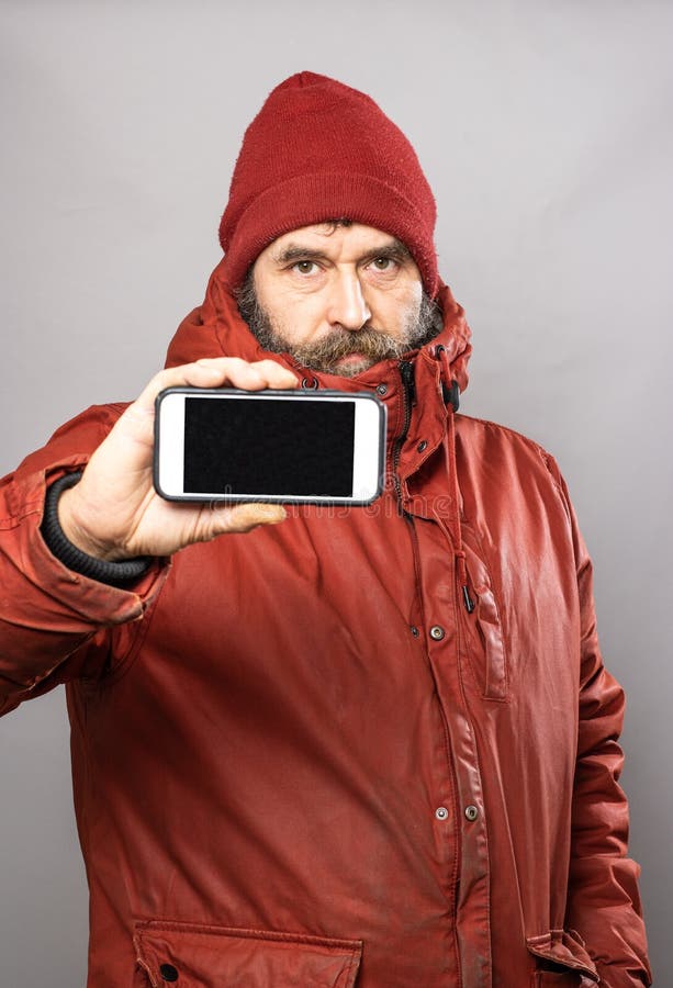 Man Showing Smart Phone Screen into Camera in Winter Coat Freezing in ...