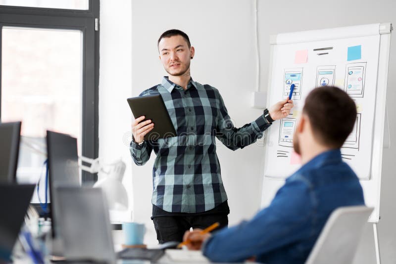 Man Showing Tablet Pc To Creative Team at Office Stock Photo - Image of ...