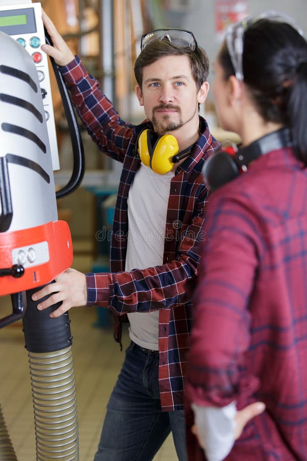 Man Showing Woman Extractor Hose in Workshop Stock Photo - Image of ...