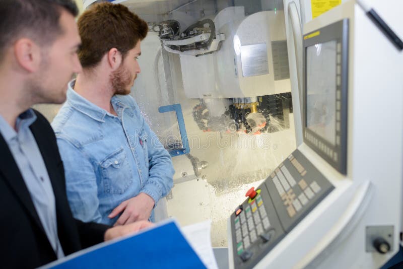 Man Showing Working Machinery To Apprentice Stock Image - Image of ...