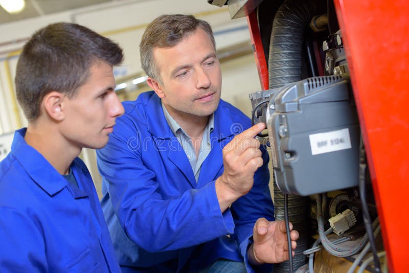 Man Showing Working Machinery To Apprentice Stock Photo - Image of ...