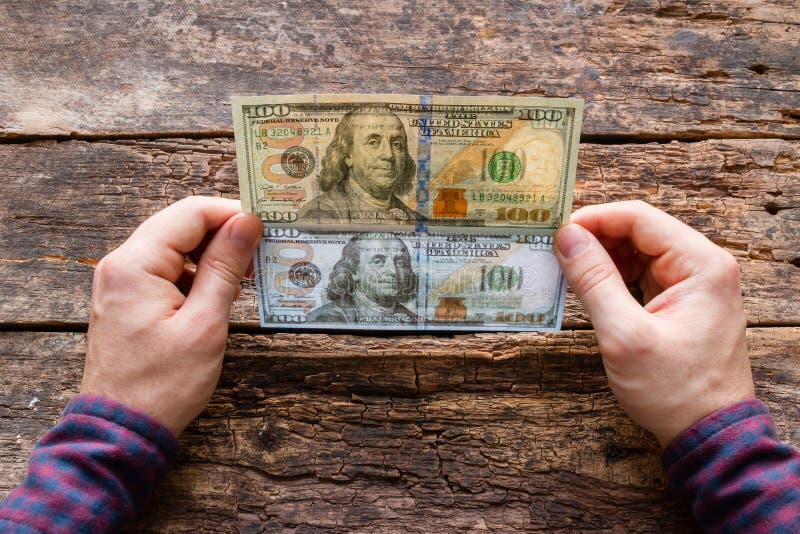 Man Shows the Difference between an Authentic and Fake Banknote Stock ...