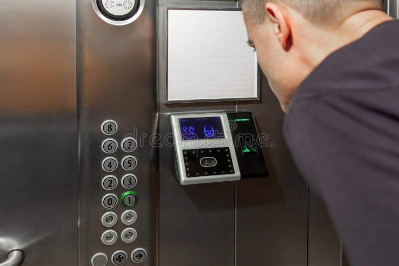 A Man Shows His Face To a Fingerprint Access Control Terminal with a ...