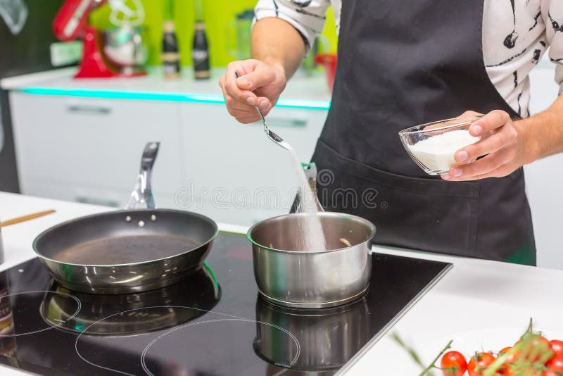 Man Sifting Sugar in the Pan Stock Image - Image of burner, hand: 77779805