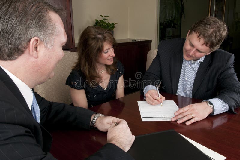 Man Signing Contract with Wife and Attorney Stock Photo - Image of ...