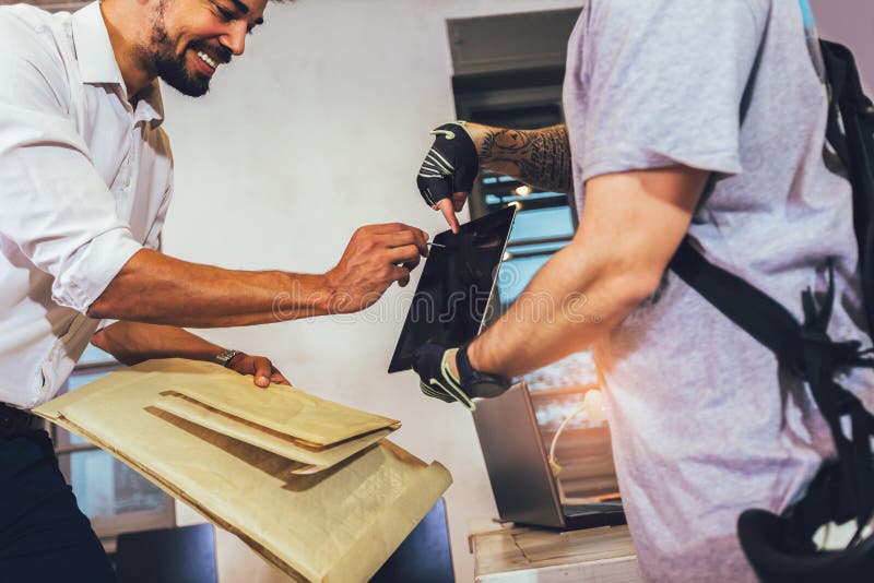 Man Signing of Delivery Package Stock Photo - Image of pack, carton ...