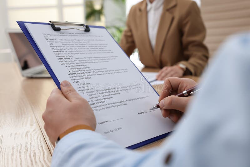 Man Signing Employment Agreement at Table in Office, Closeup. Work ...