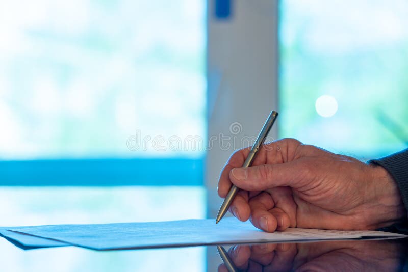 Man Signs a Document Form with a Ballpoint Pen in the Office Stock ...