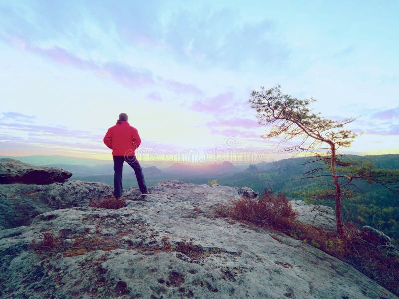 Man Silhouette on Cliff. Hiker in Red Jacket Climbed Up To Peak Enjoy ... Man Silhouette on Cliff. Hiker in Red Jacket Climbed Up To Peak Enjoy ...