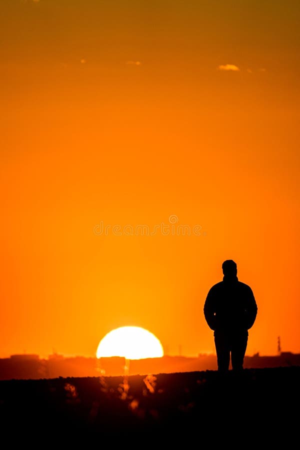 Man Silhouette Standing Against a Backdrop of a Stunning Sunset, His ...
