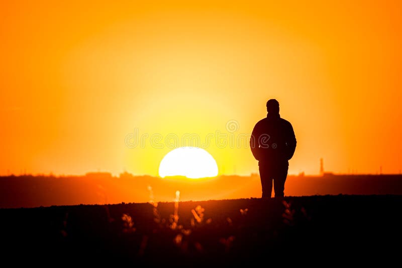 Man Silhouette Standing Against a Backdrop of a Stunning Sunset, His ...