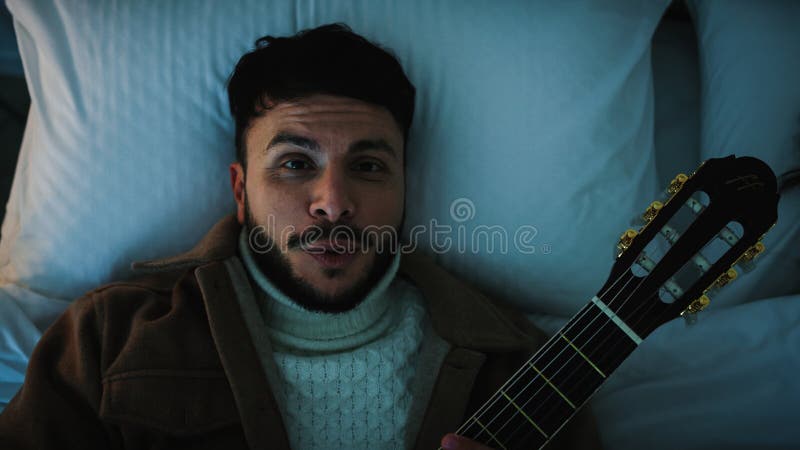 Man Sing and Play the Guitar in a Bed Stock Photo - Image of guitarist ...