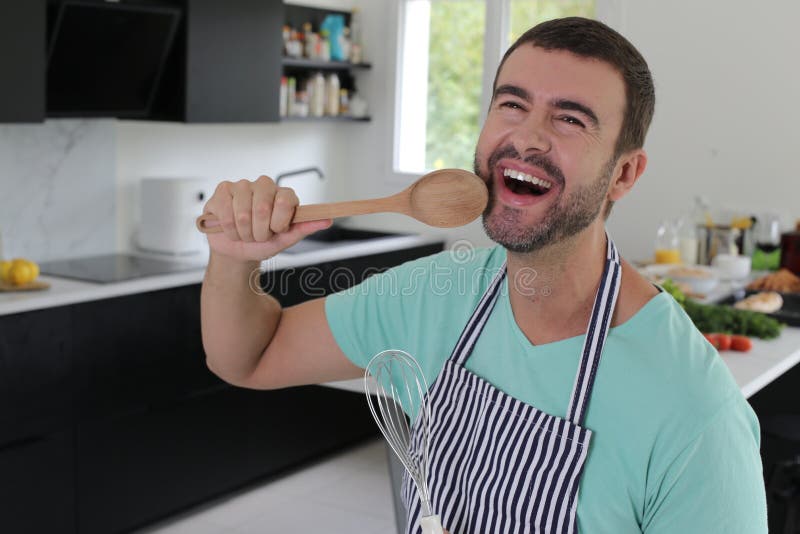 Man singing in the kitchen stock photo. Image of indoors - 258703186