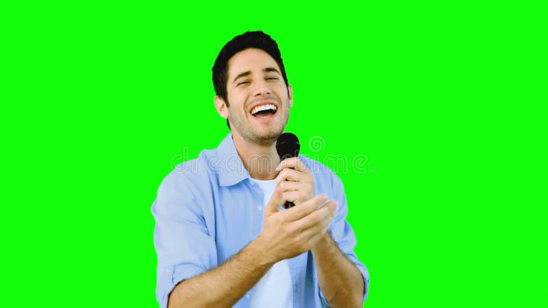 Man Singing into Microphone with Emotion on Green Screen Stock Video ...