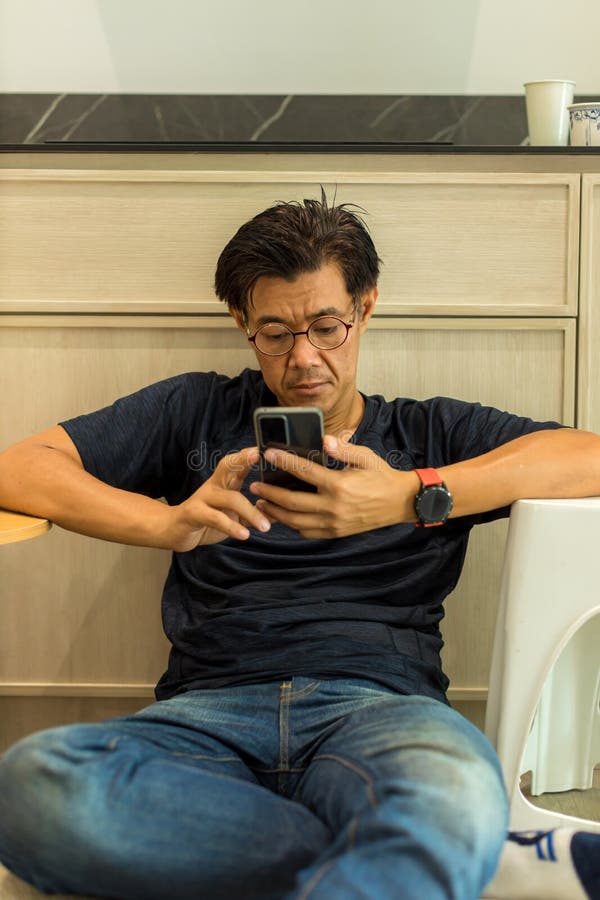 Man Sit Down and Using Mobile and Social Media. Man Playing on Him ...