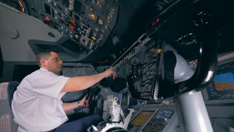 A Pilot Practices in a Special Plane Simulator, Side View. Stock ...