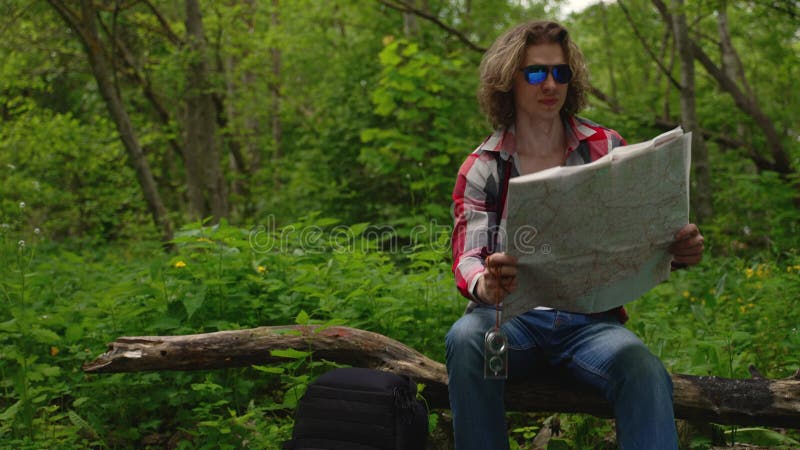 Man Sits with Compass and Map. Stock Footage - Video of longitude ...