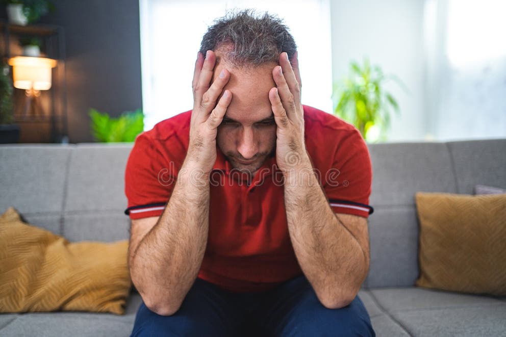Man Sitting Alone at Home Looking Sad and Distraught Stock Photo ...
