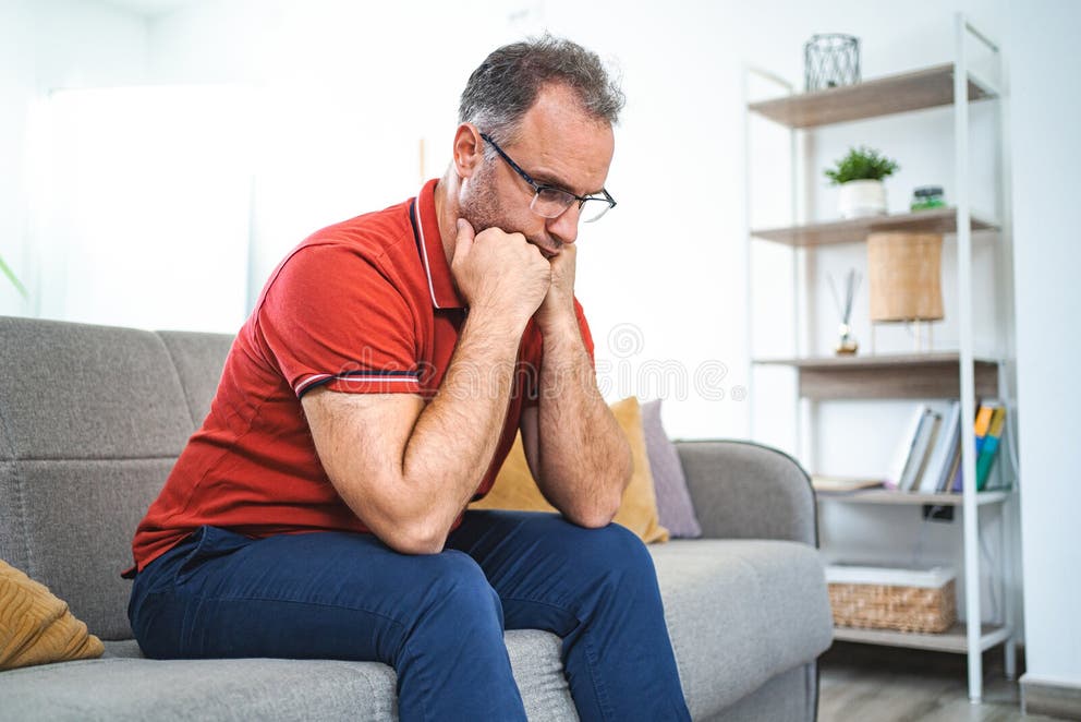Man Sitting Alone at Home Looking Sad and Distraught Stock Image ...