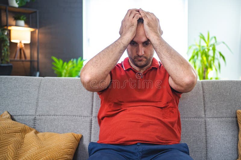 Man Sitting Alone at Home Looking Sad and Distraught Stock Photo ...