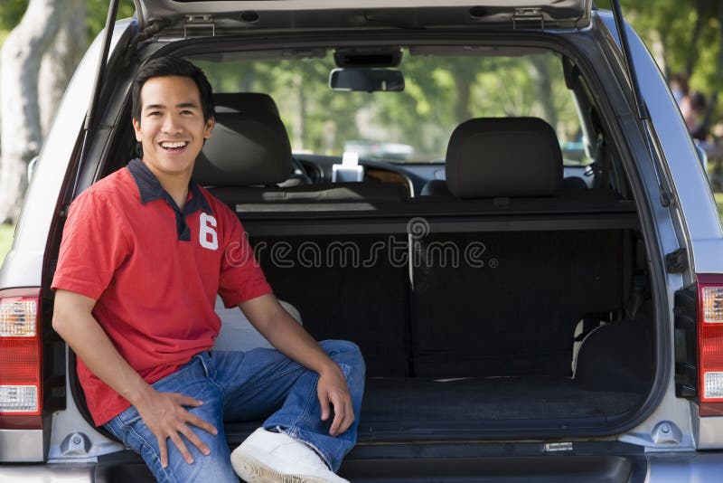 Couple Sitting in Back of Van Smiling Stock Photo - Image of camera ...