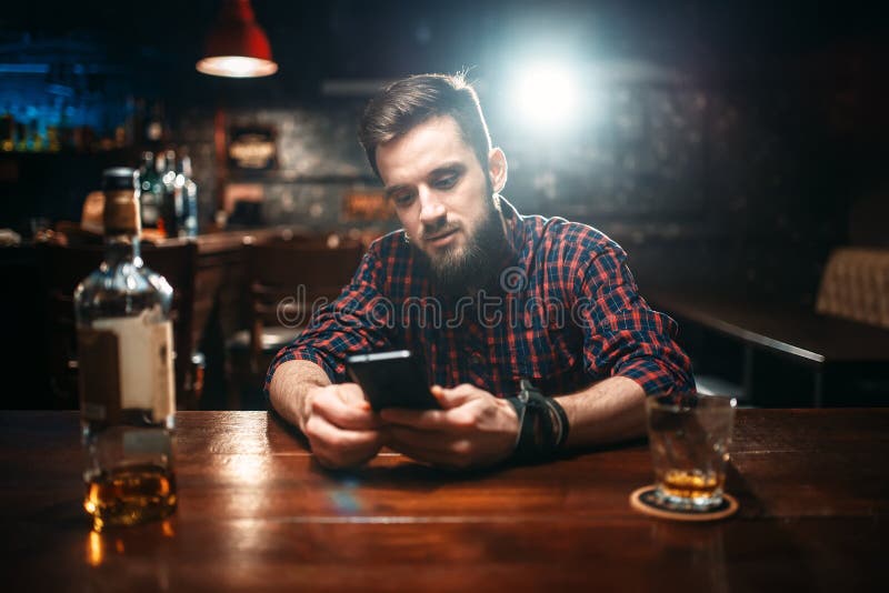 Man Sitting at Bar Counter and Using His Phone Stock Photo - Image of ... Man Sitting at Bar Counter and Using His Phone Stock Photo - Image of ...