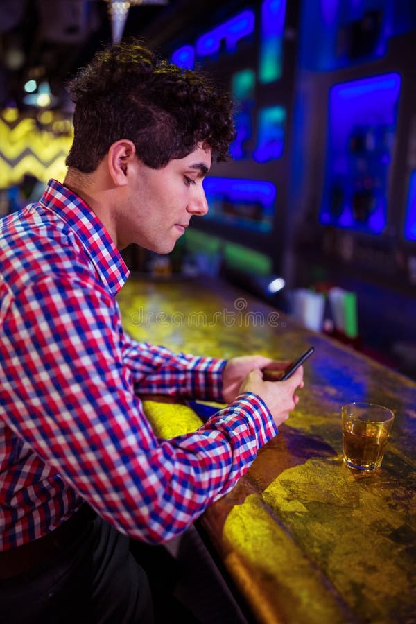 Man sitting at bar counter stock photo. Image of male - 77710578