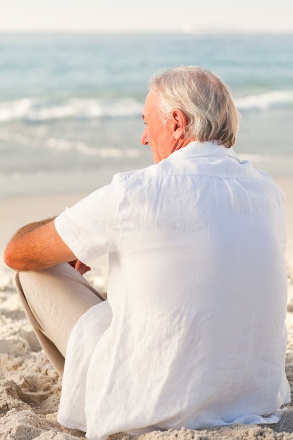 Handsome Man Relaxing on the Beach Sitting on Seaside Sand and Looking ...