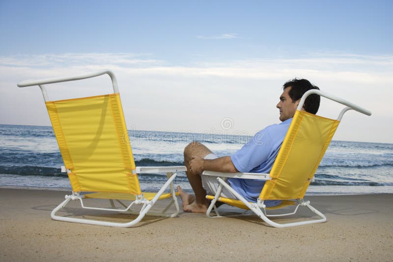 Man Sitting on Beach Alone stock photo. Image of hair - 12676154
