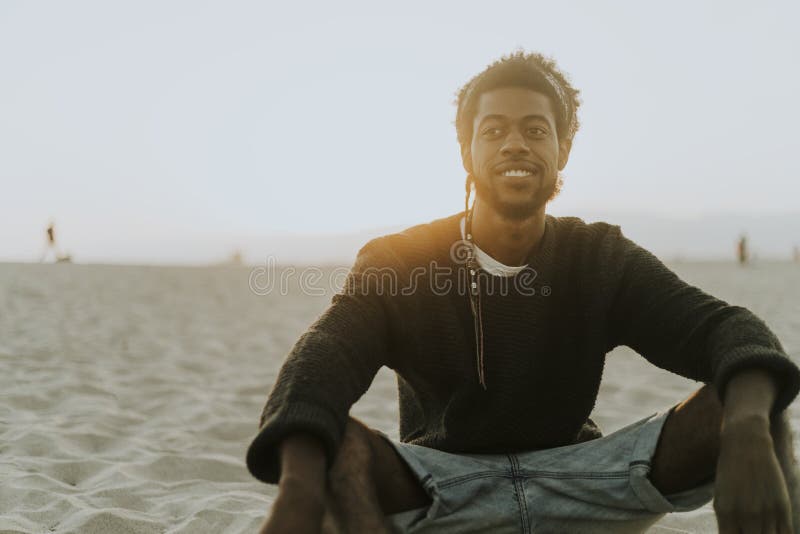 Man sitting at the beach stock image. Image of sand - 126906259