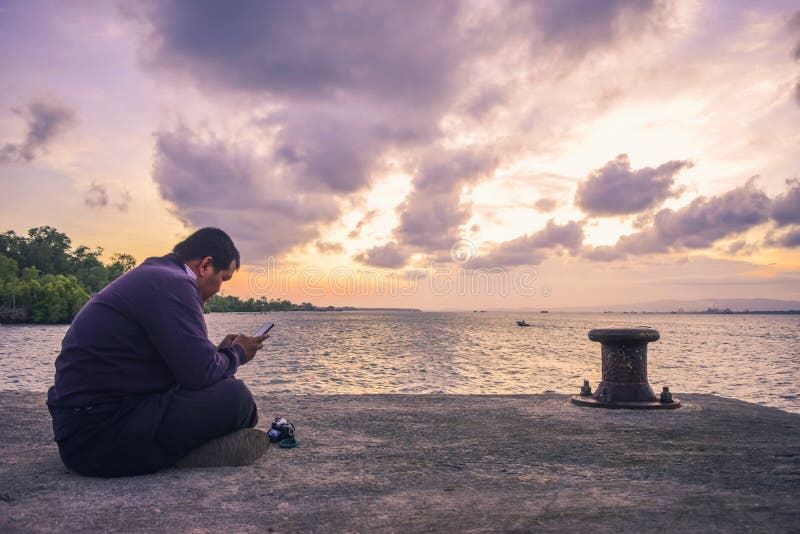 Man Sitting on the Beach at Sunset Stock Image - Image of people, ocean ...