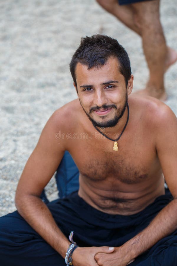 Man sitting on a beach stock photo. Image of masculine - 77935598