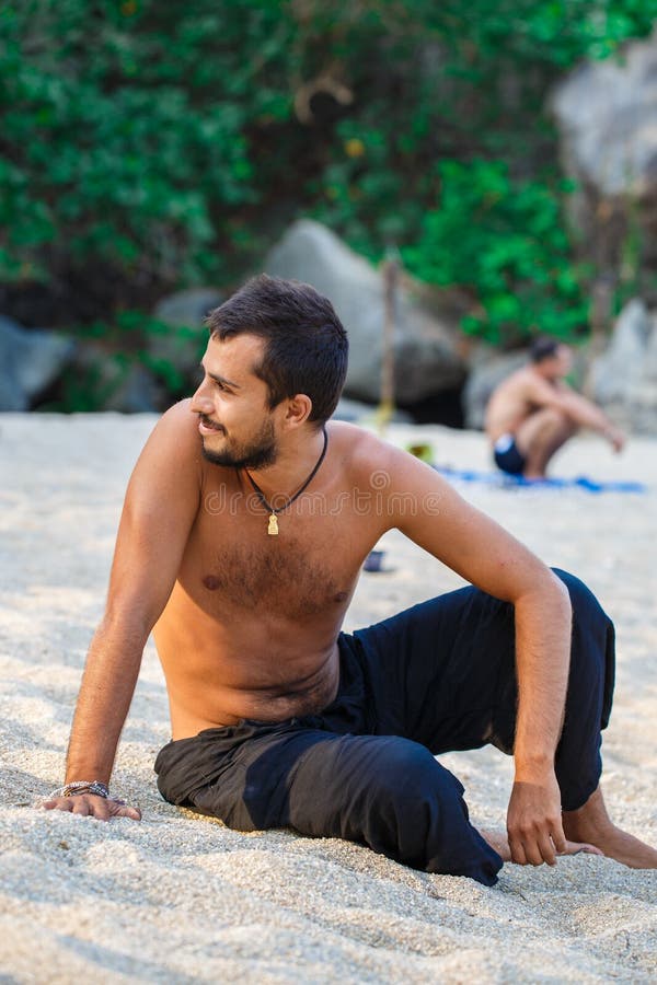Man sitting on a beach stock photo. Image of masculine - 77935598